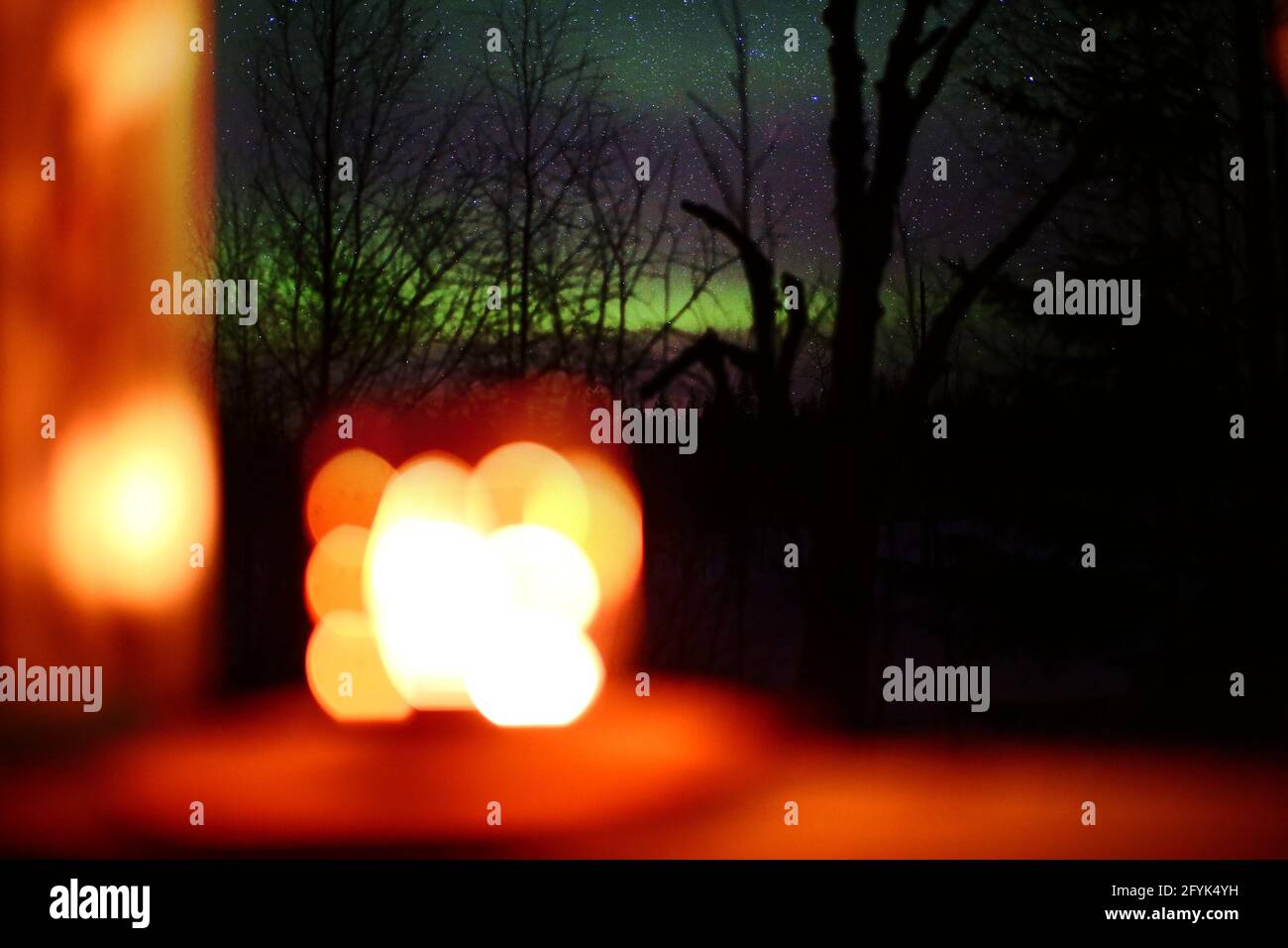 Northern lights and defocused candle in foreground Stock Photo - Alamy