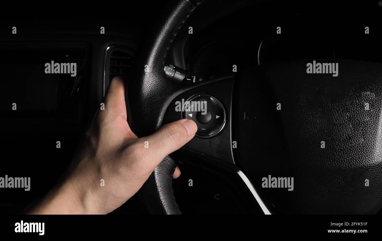 Steering wheel and man hand. Black leather modern car Interior close up ...