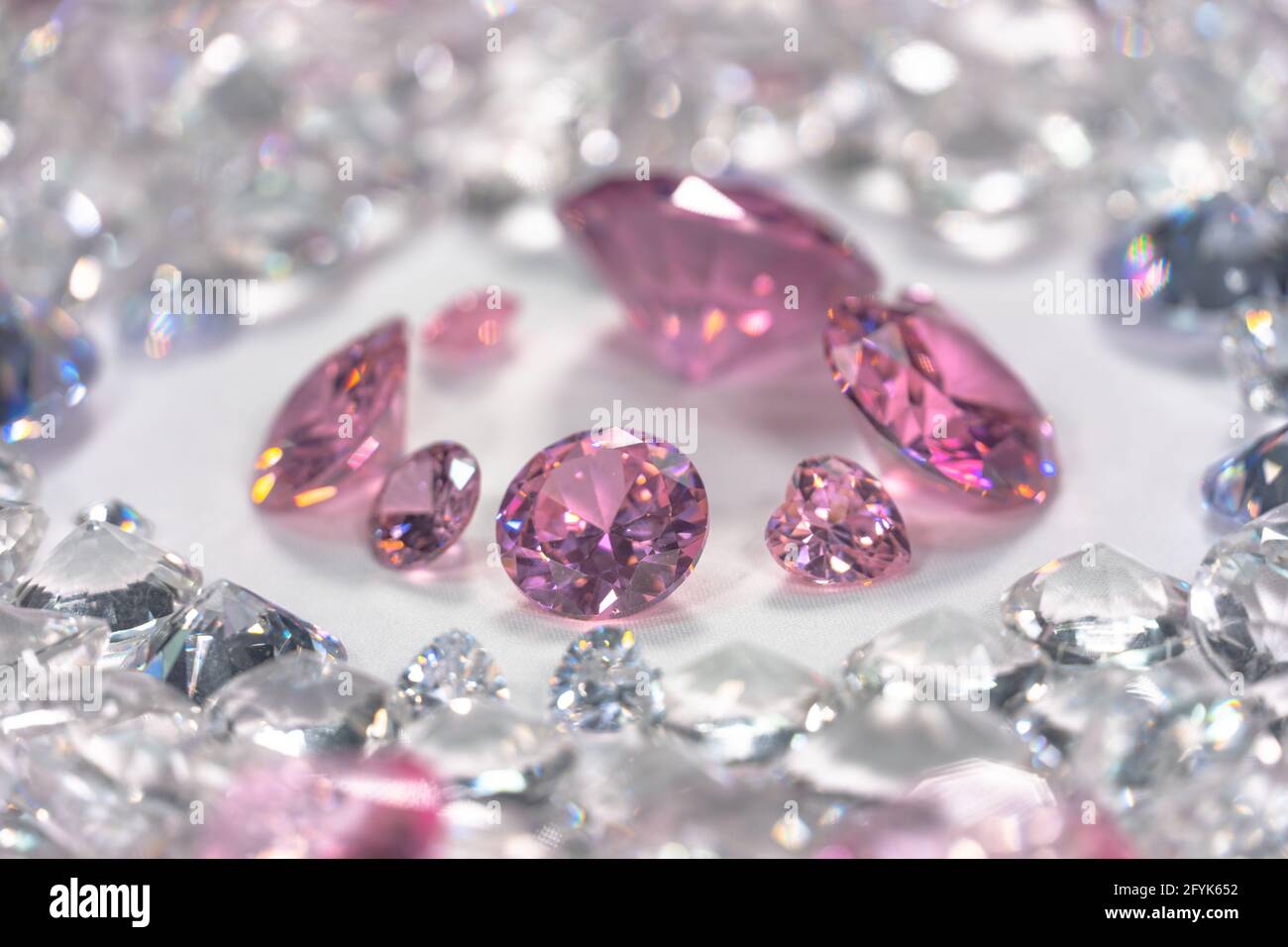 A group of pink diamonds arranged in the middle of white diamonds in a ...