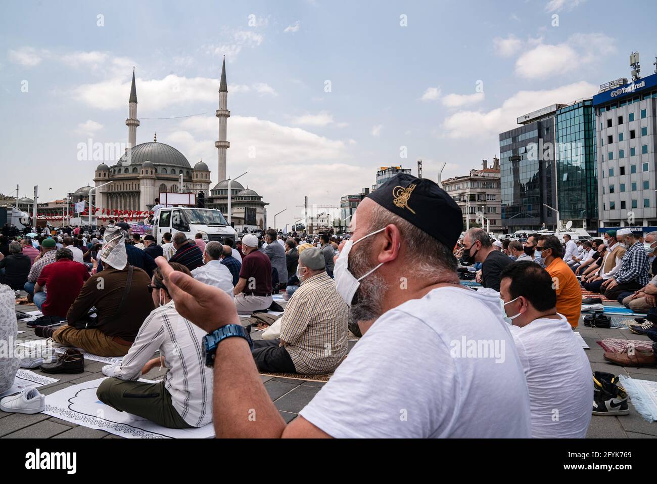 People attend the Friday prayers outside the Taksim Mosque. Turkish ...
