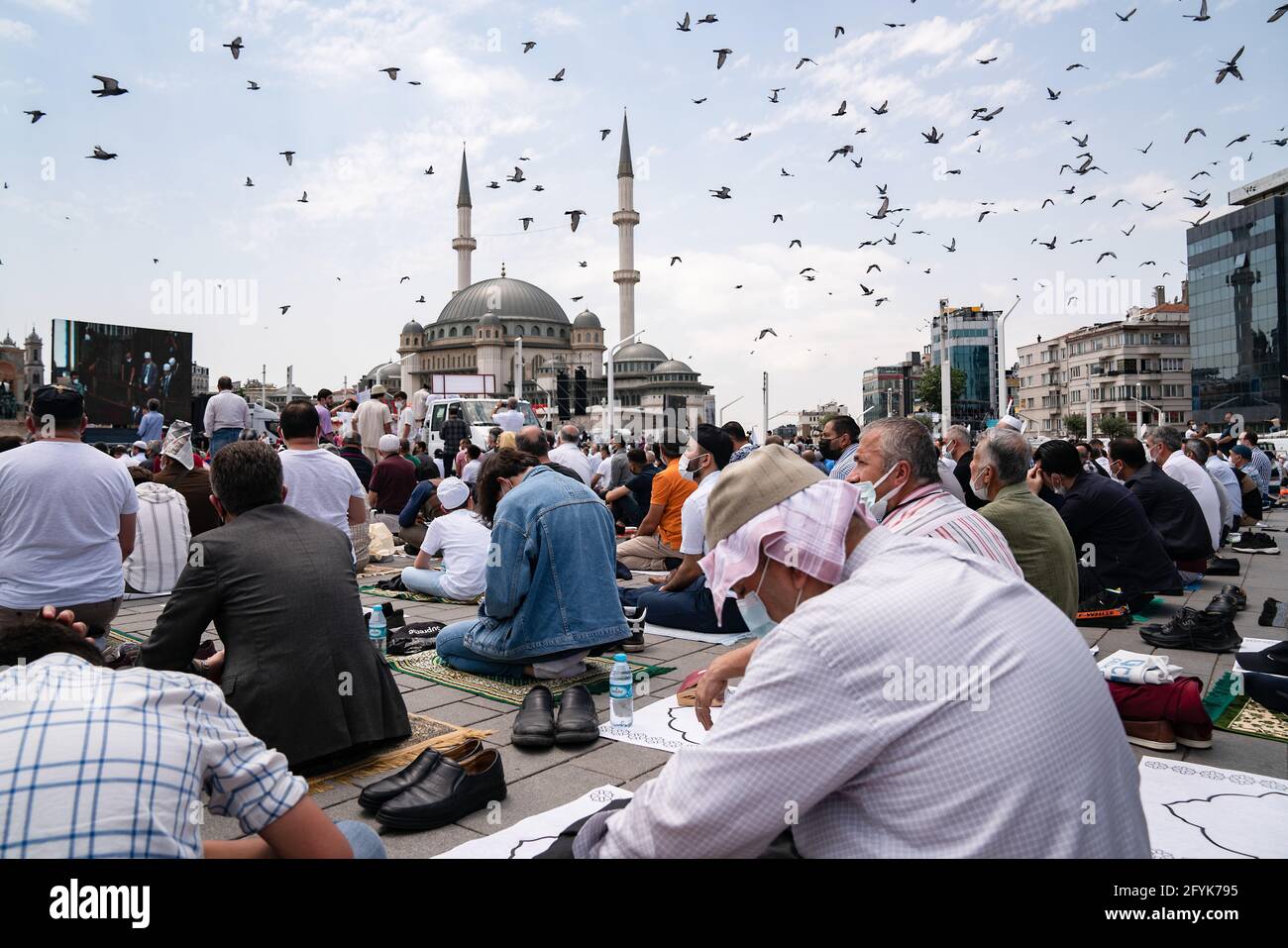 People attend the Friday prayers outside the Taksim Mosque. Turkish ...