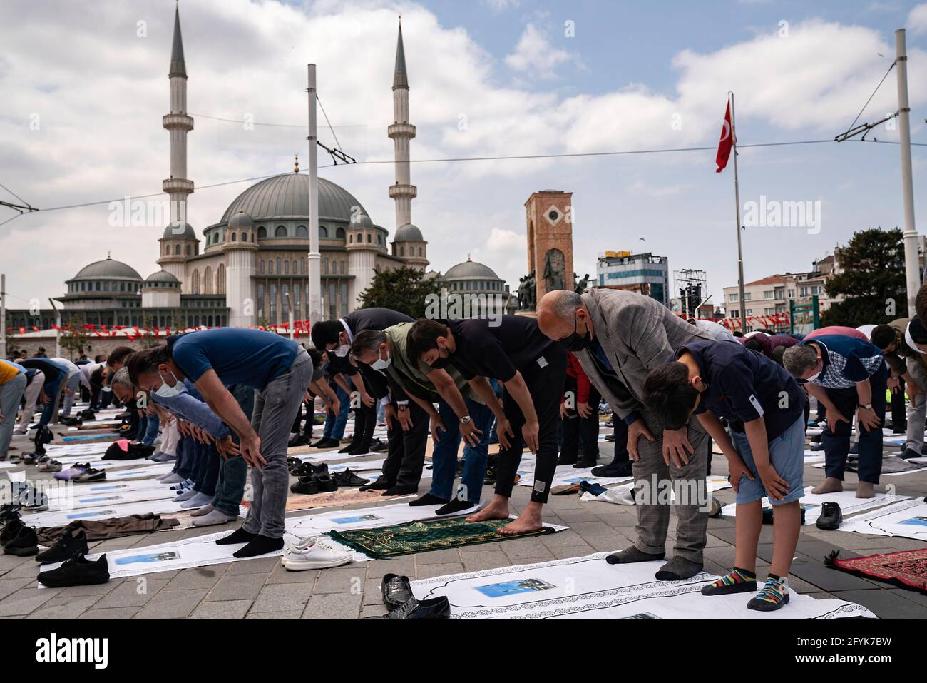 People attend the Friday prayers outside the Taksim Mosque. Turkish ...