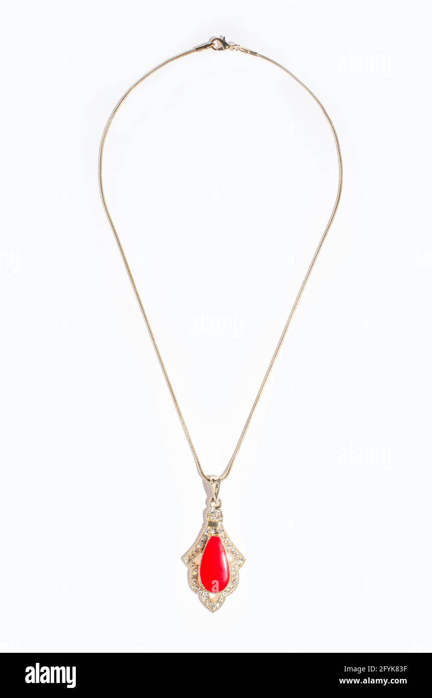 Indian gold pendant with red gem on a white background Stock Photo - Alamy