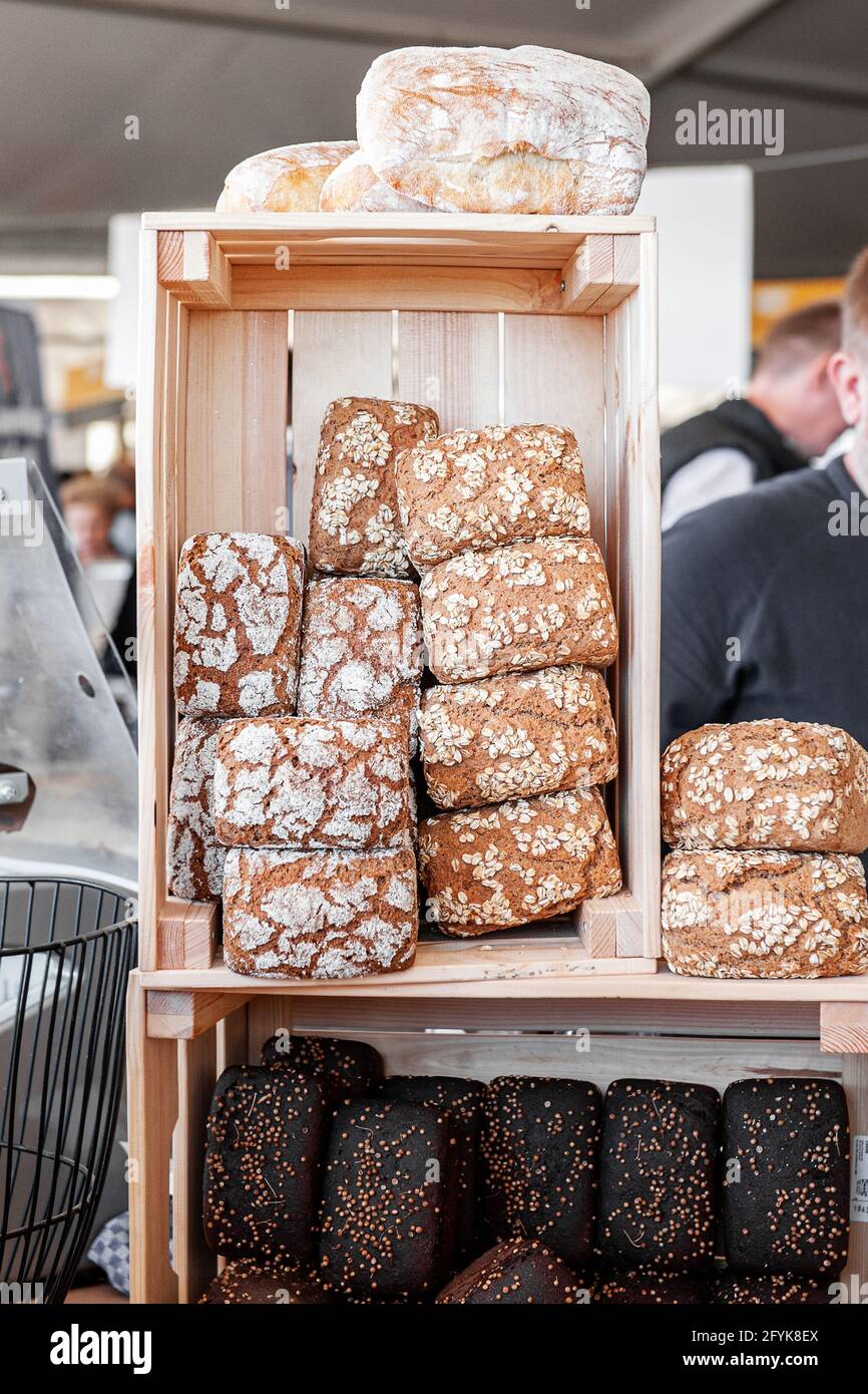 An assortment of artisan bread is displayed in the vertical display ...