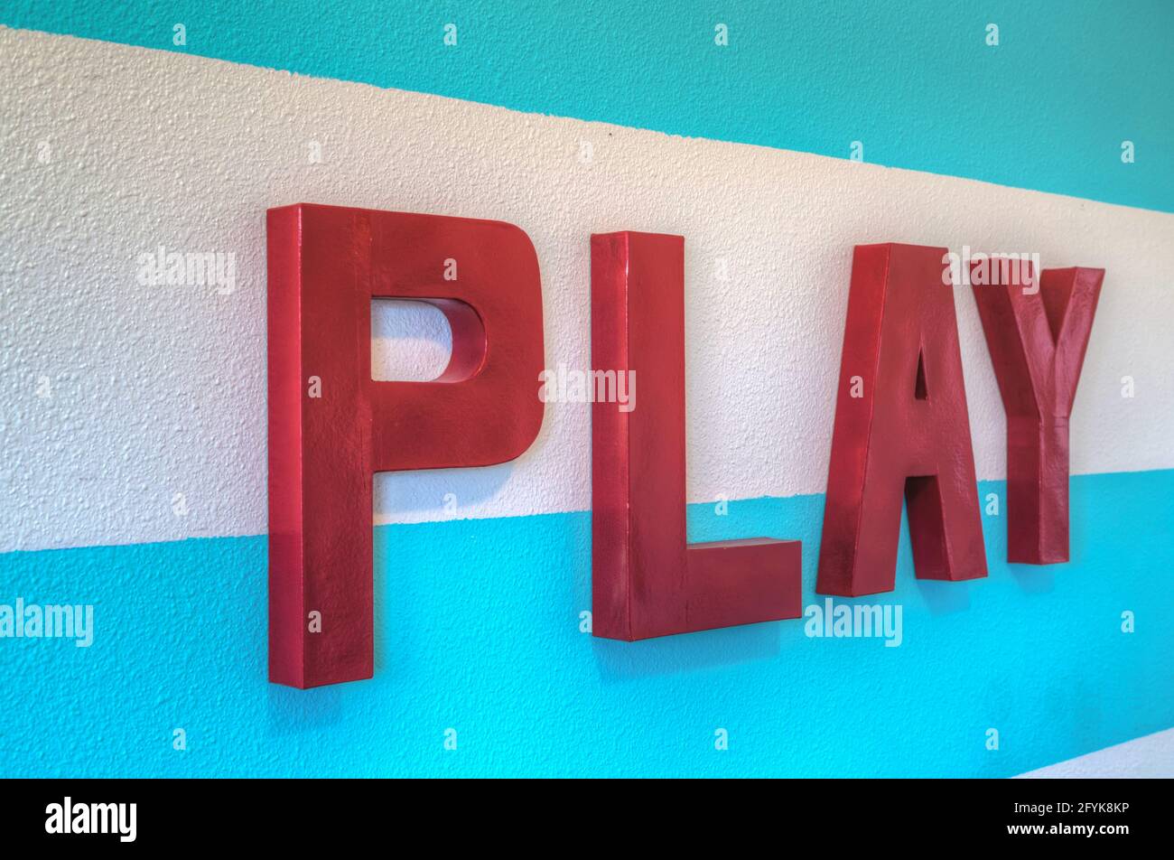 Giant PLAY sign with blue striped background Stock Photo - Alamy