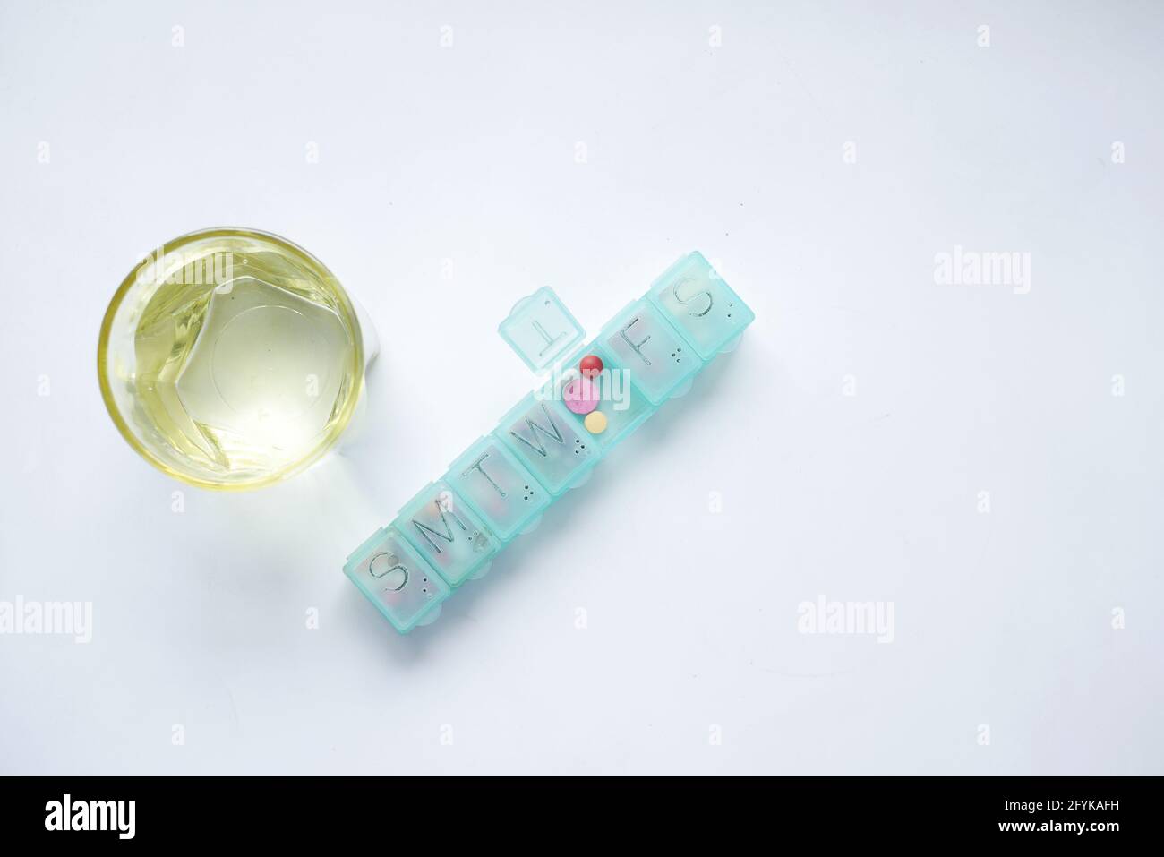 pill box fill with medical capsule and glass on white background Stock ...