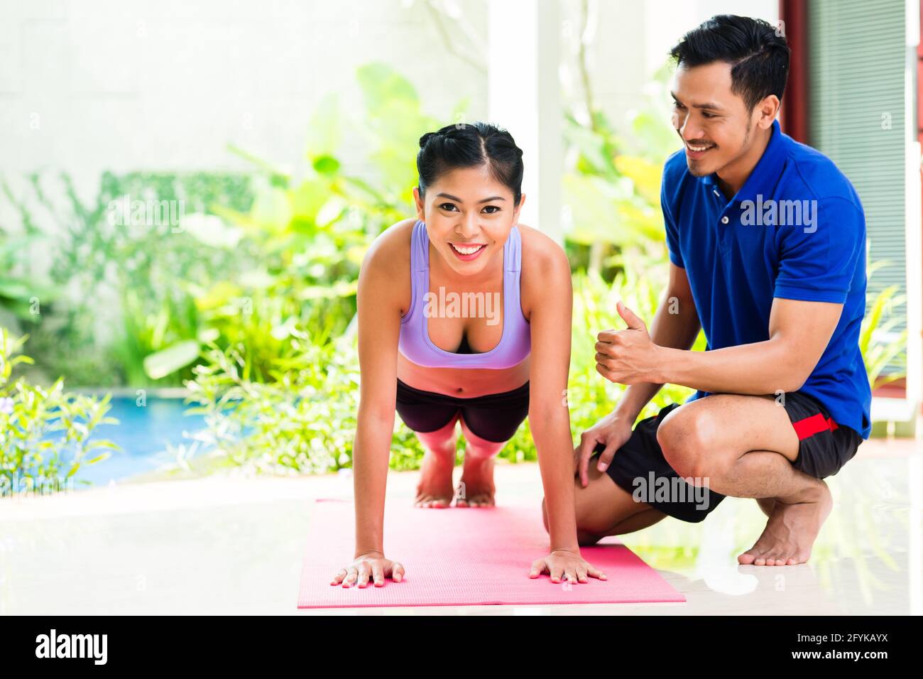 Asian woman and personal trainer at sport exercise doing push-ups Stock ...
