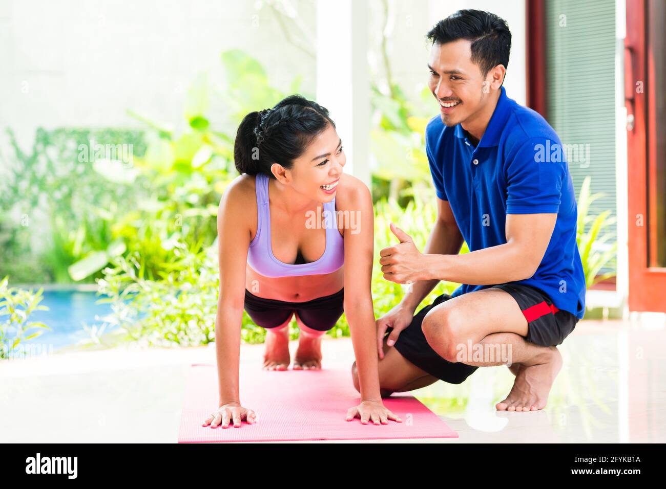 Asian woman and personal trainer at sport exercise doing push-ups Stock ...