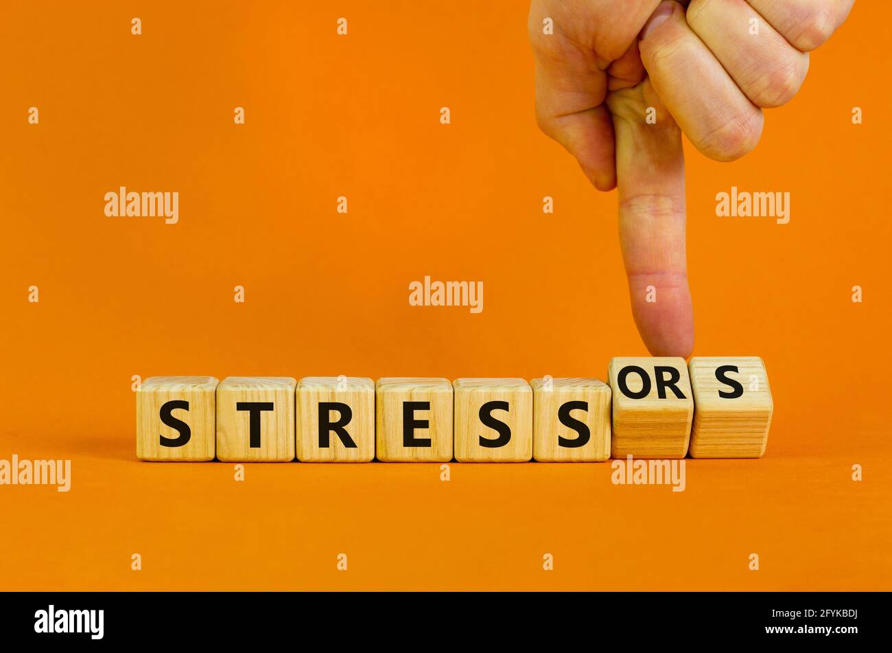 Stress and stressors symbol. Businessman turns cubes, changes words ...
