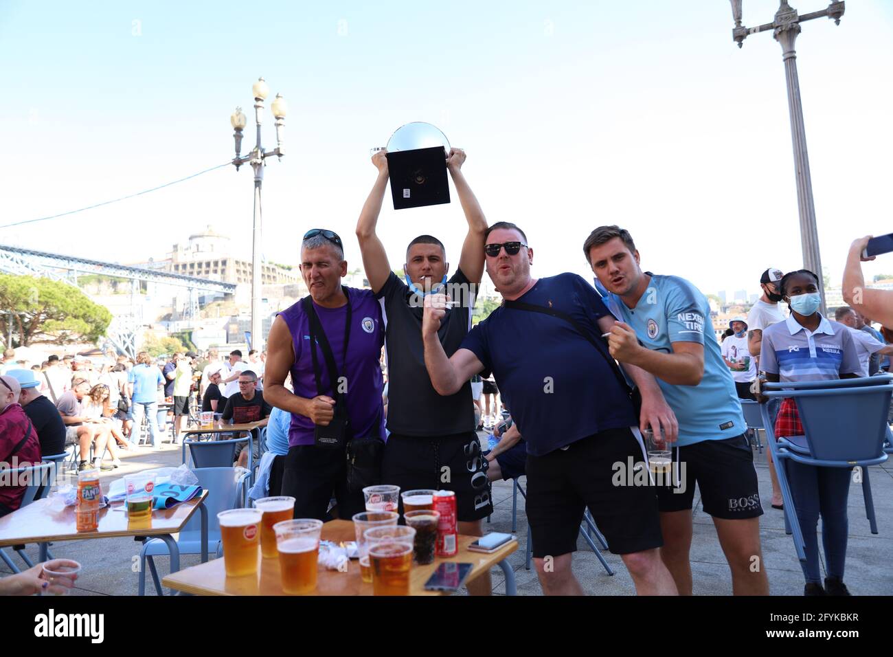 English fans of Chelsea and Manchester City drink beer in the host city ...