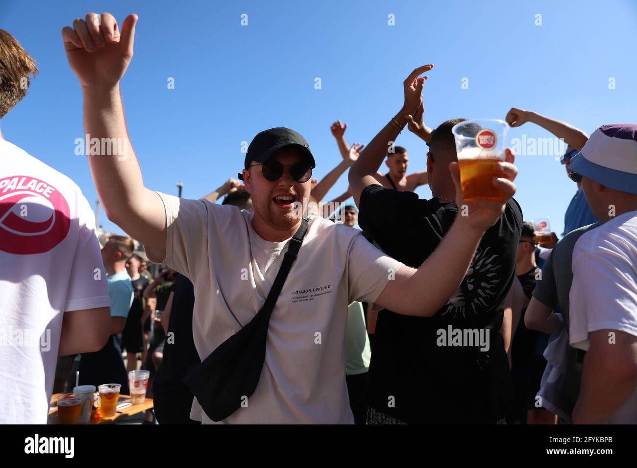 English fans of Chelsea and Manchester City drink beer in the host city ...