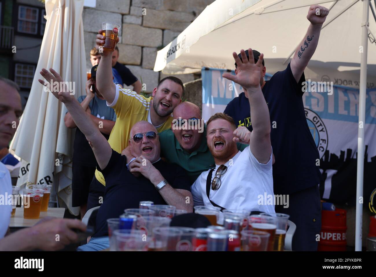 English fans of Chelsea and Manchester City drink beer in the host city ...