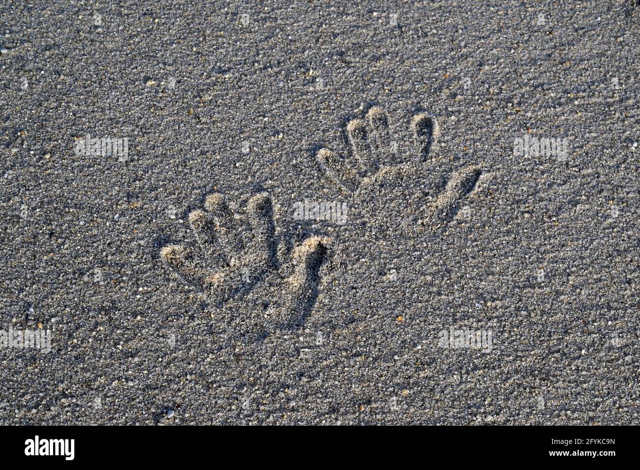Hand prints in sand on the beach Stock Photo - Alamy