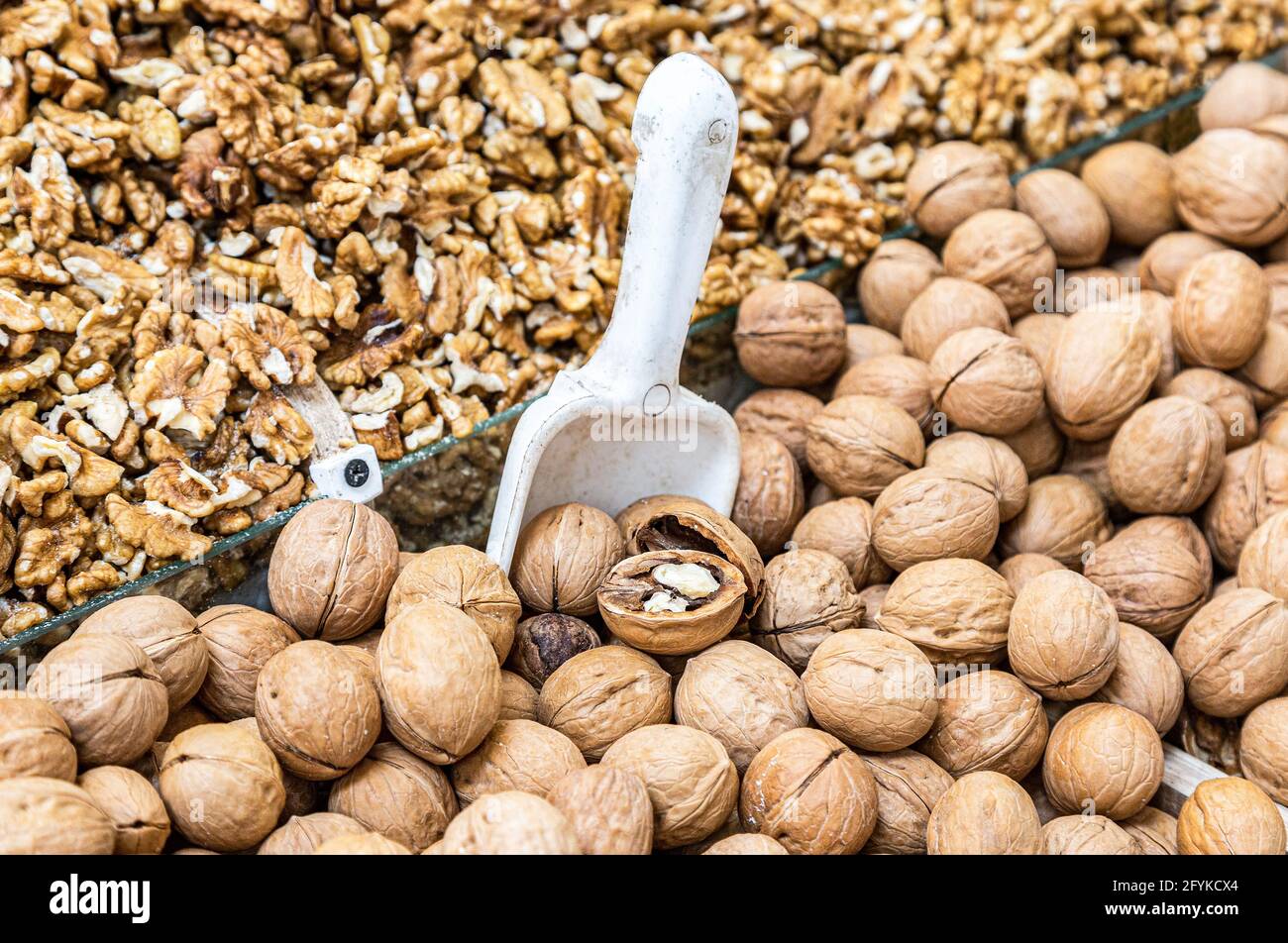 Walnut kernels and whole walnuts are sold at the grocery store Stock ...