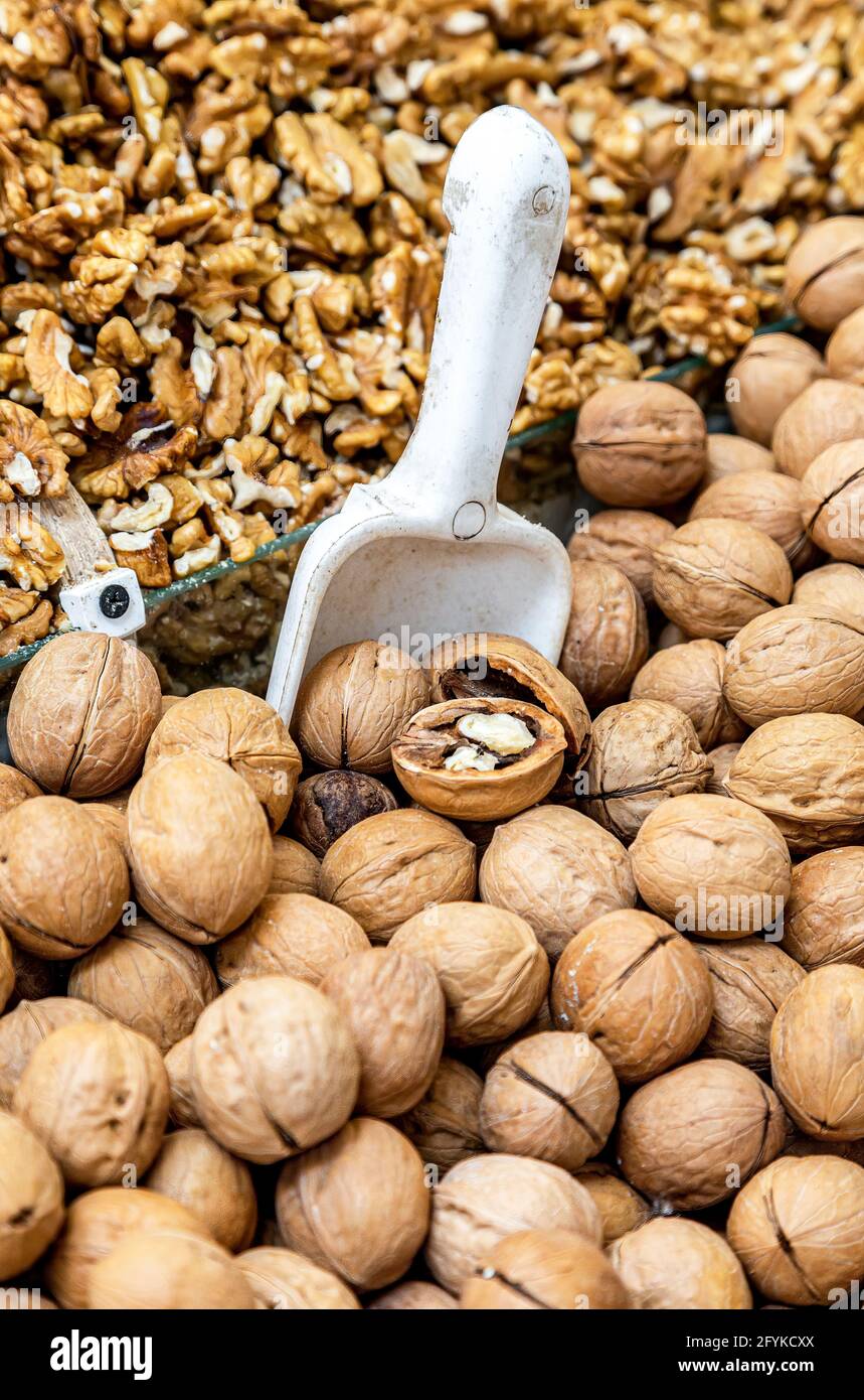 Walnut kernels and whole walnuts are sold at the grocery store Stock ...