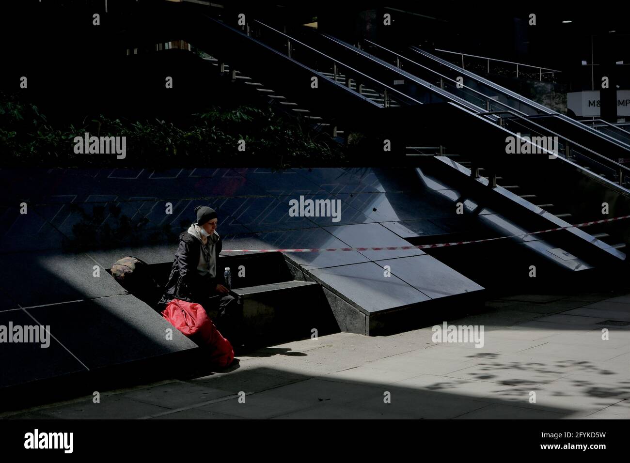 Homeless person sitting street backpack hi-res stock photography and ...