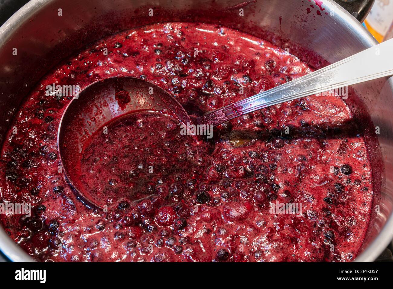 Red fruit jam being cooked in a saucepan Stock Photo - Alamy