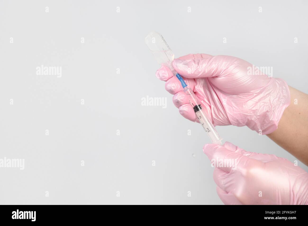 Hand pink gloves injecting hi-res stock photography and images - Alamy
