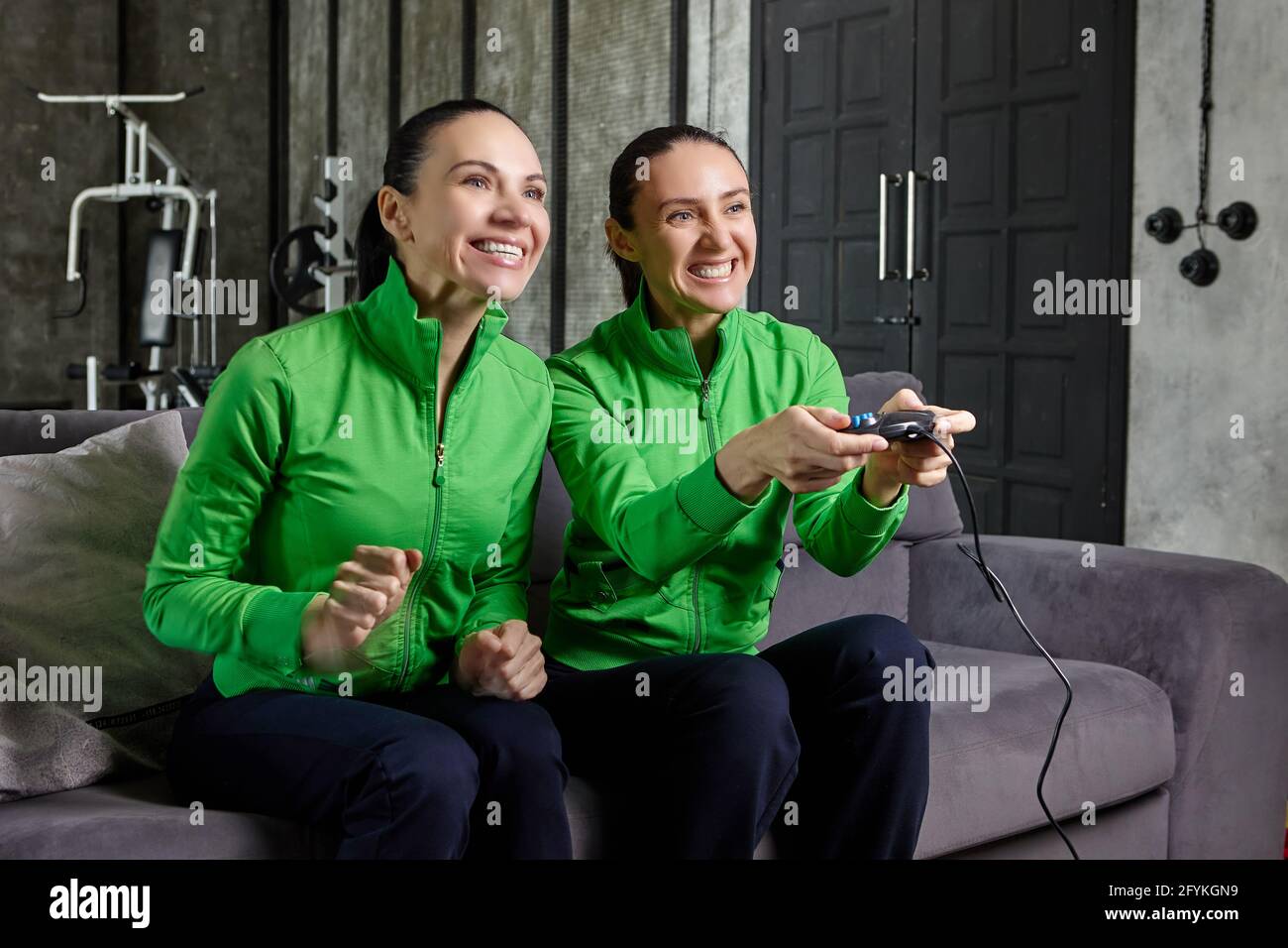Adult women play video games using joystick from game console Stock ...