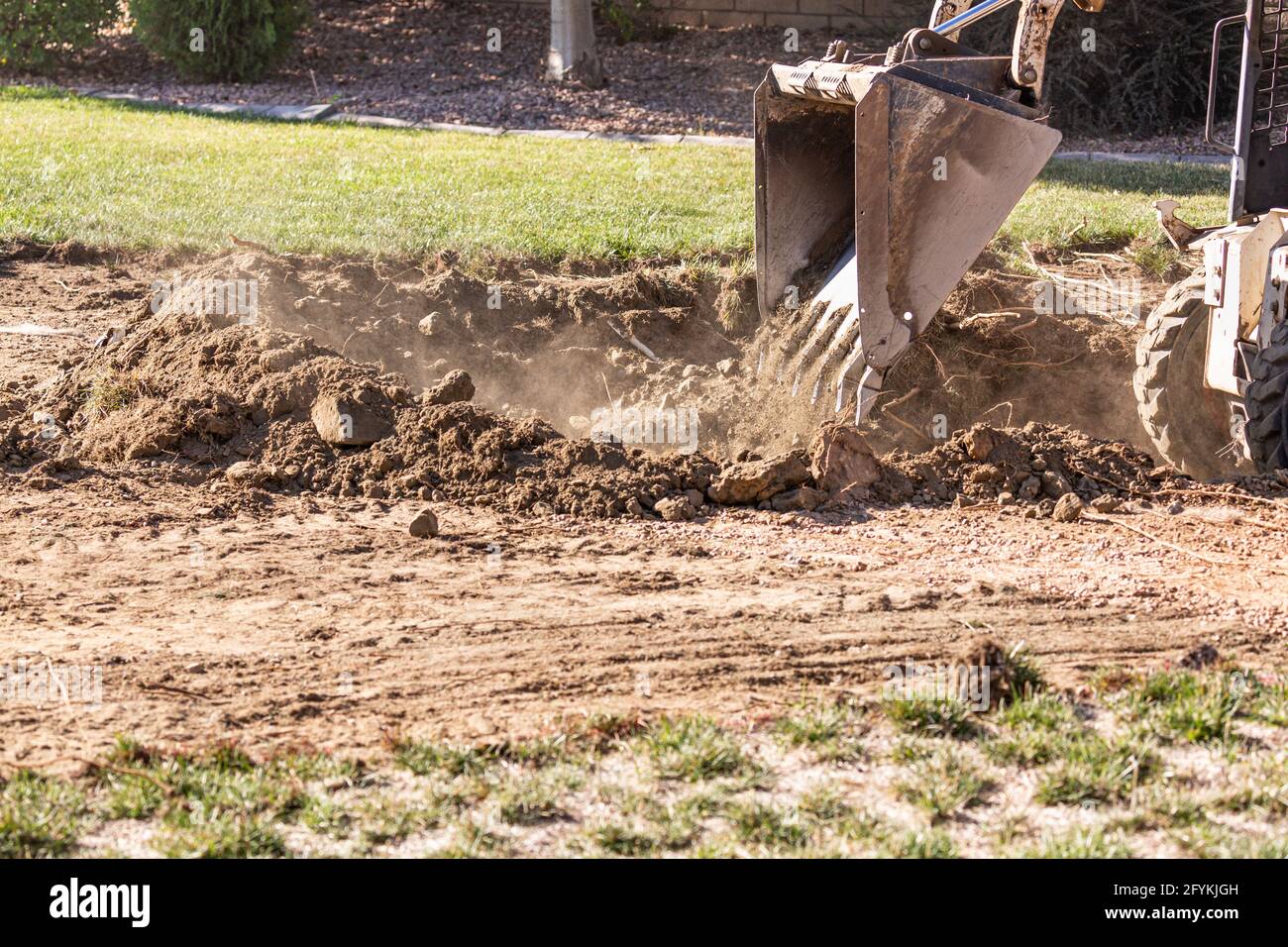 Small Bulldozer Digging In Yard For Pool Installation Stock Photo - Alamy