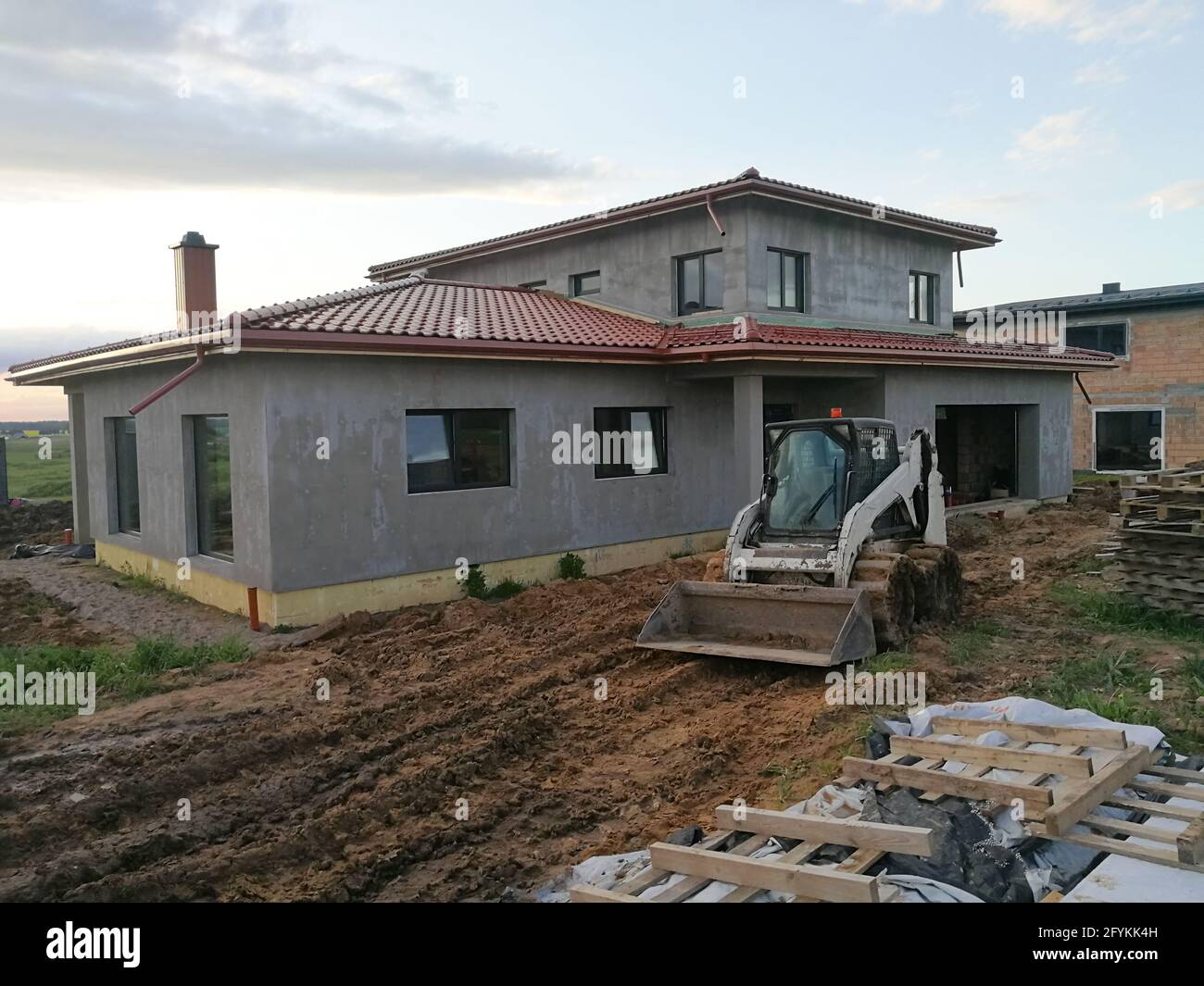 Small ground work bulldozer in construction site in front of individual ...