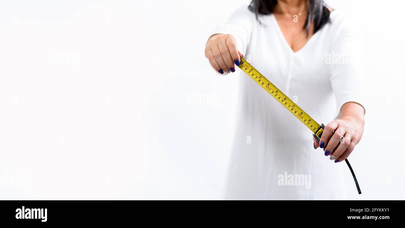 Hands holding tape measure - Latin woman Stock Photo - Alamy