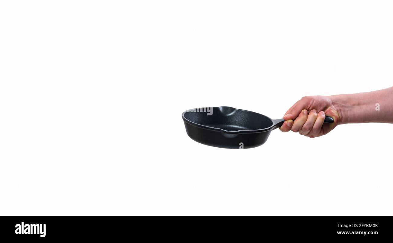 Hand holding teflon frying pan - Latin man Stock Photo - Alamy