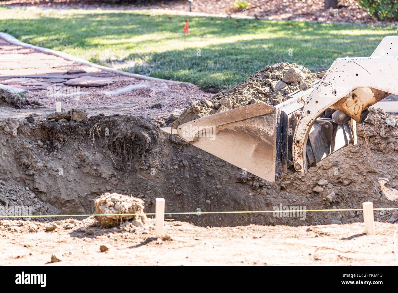 Small Bulldozer Digging In Yard For Pool Installation Stock Photo - Alamy
