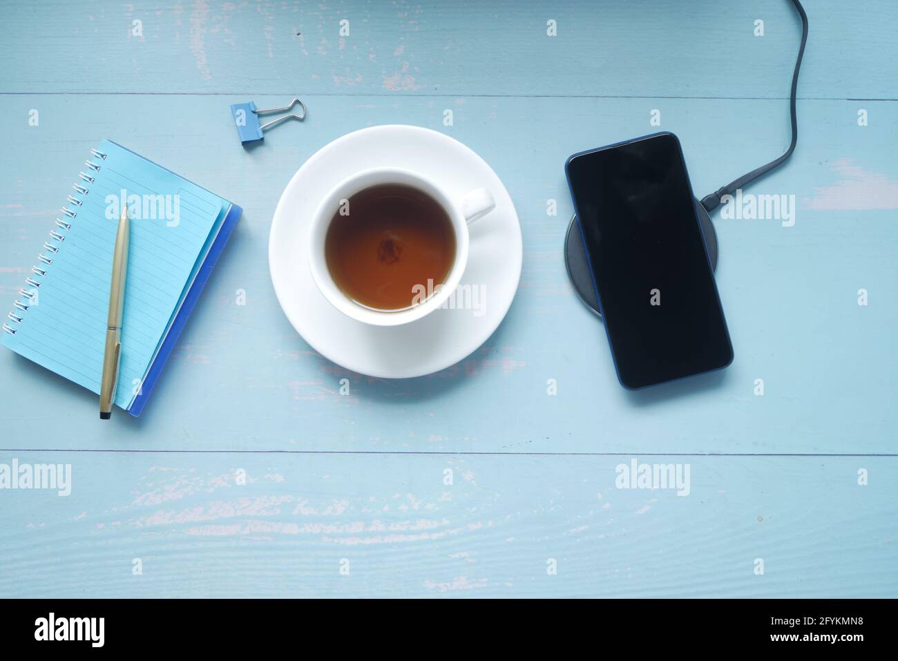 charging Smartphone using Wireless Charging Pad, top view Stock Photo ...