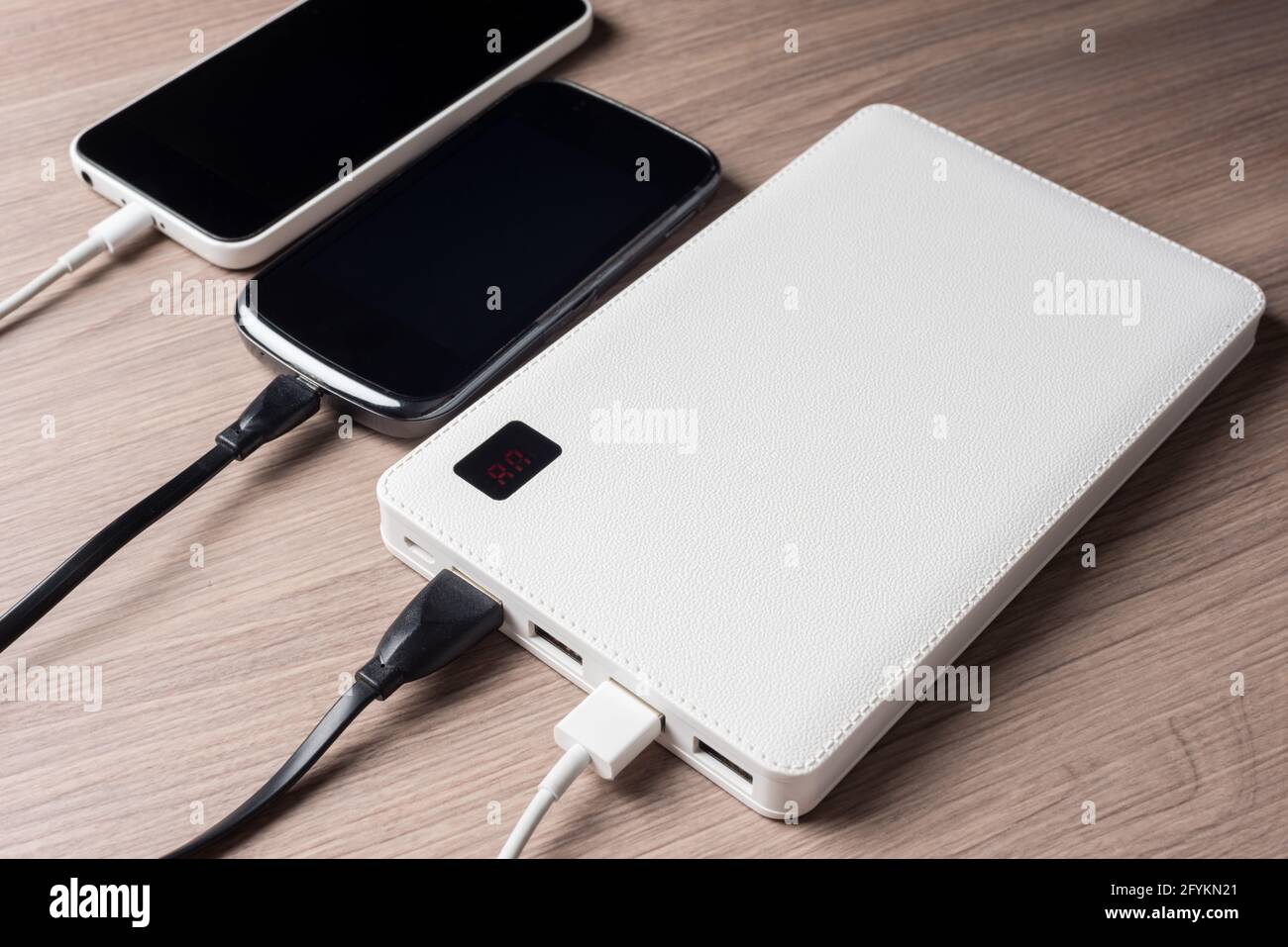Charging the empty battery smartphone with white power bank Stock Photo ...