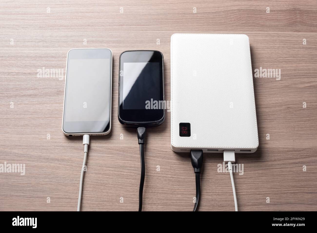 Charging the empty battery smartphone with white power bank Stock Photo ...
