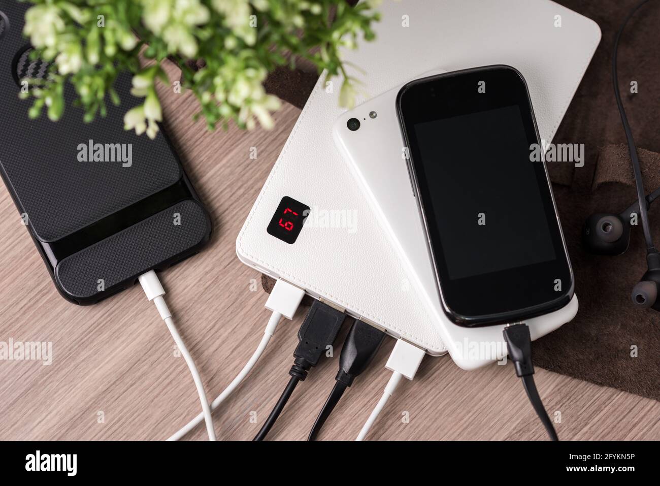 Charging the empty battery smartphone with white power bank Stock Photo ...