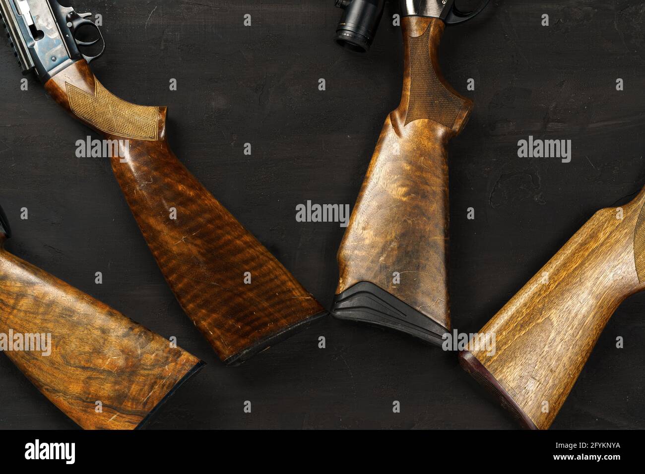Wooden handle of hunting rifle on dark wooden background Stock Photo ...