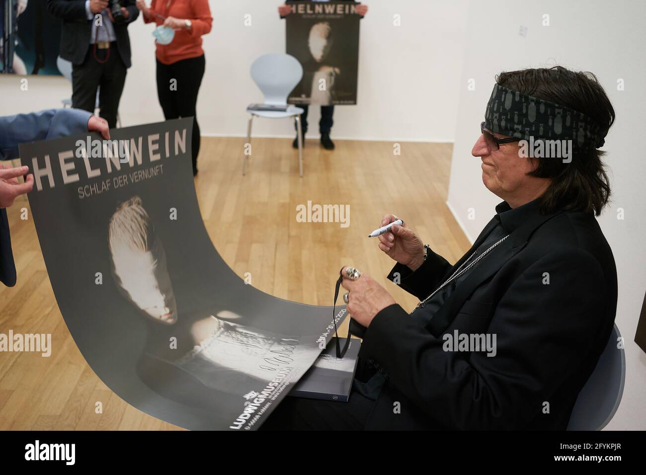 Koblenz, Germany. 28th May, 2021. The artist Gottfried Helnwein signs a ...