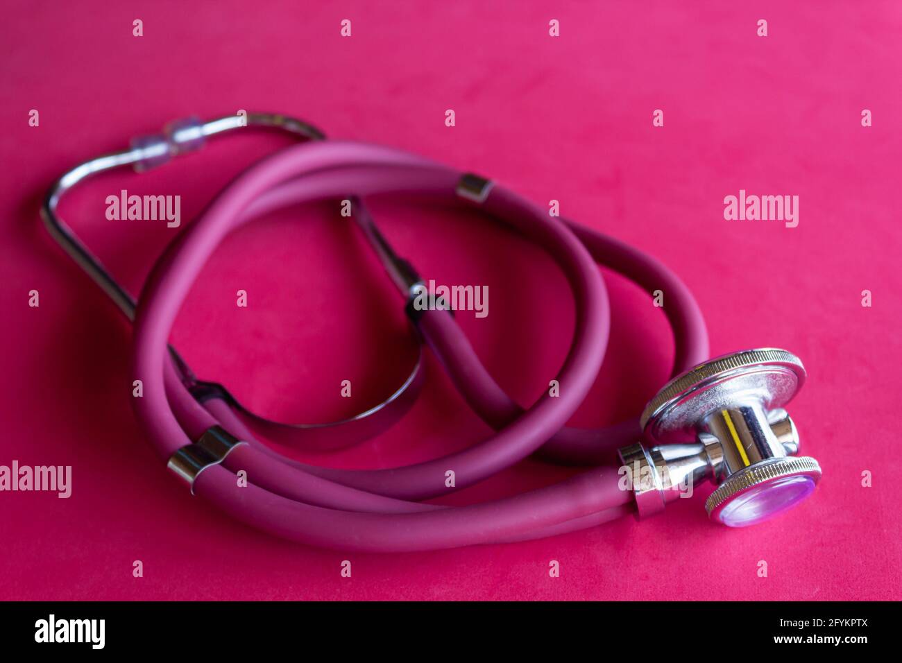 Pink stethoscope, equipment to examine respiration and heartbeat. Pink ...