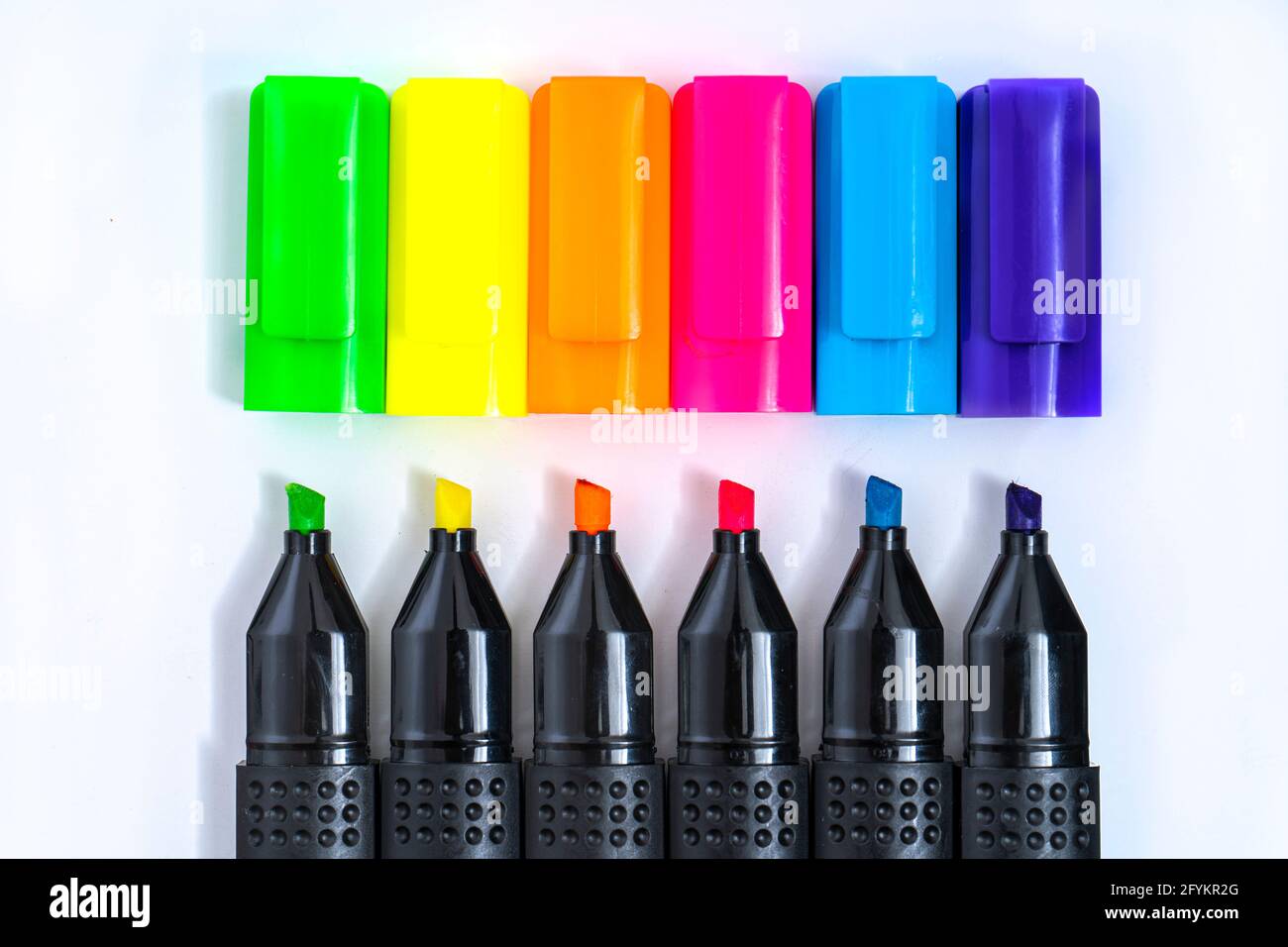 Set of highlighter markers sorted by color aligned and uncovered on ...