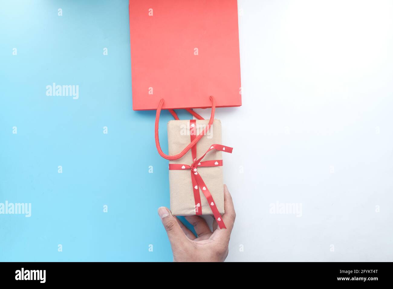 Hand putting gift hi-res stock photography and images - Alamy
