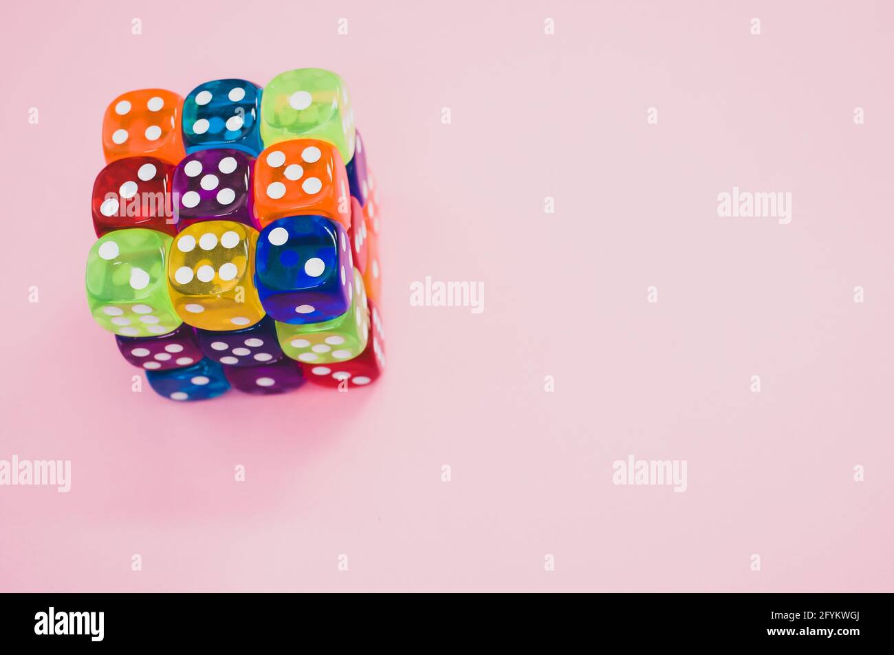 Cube made of colorful dice isolated on a pink background Stock Photo ...
