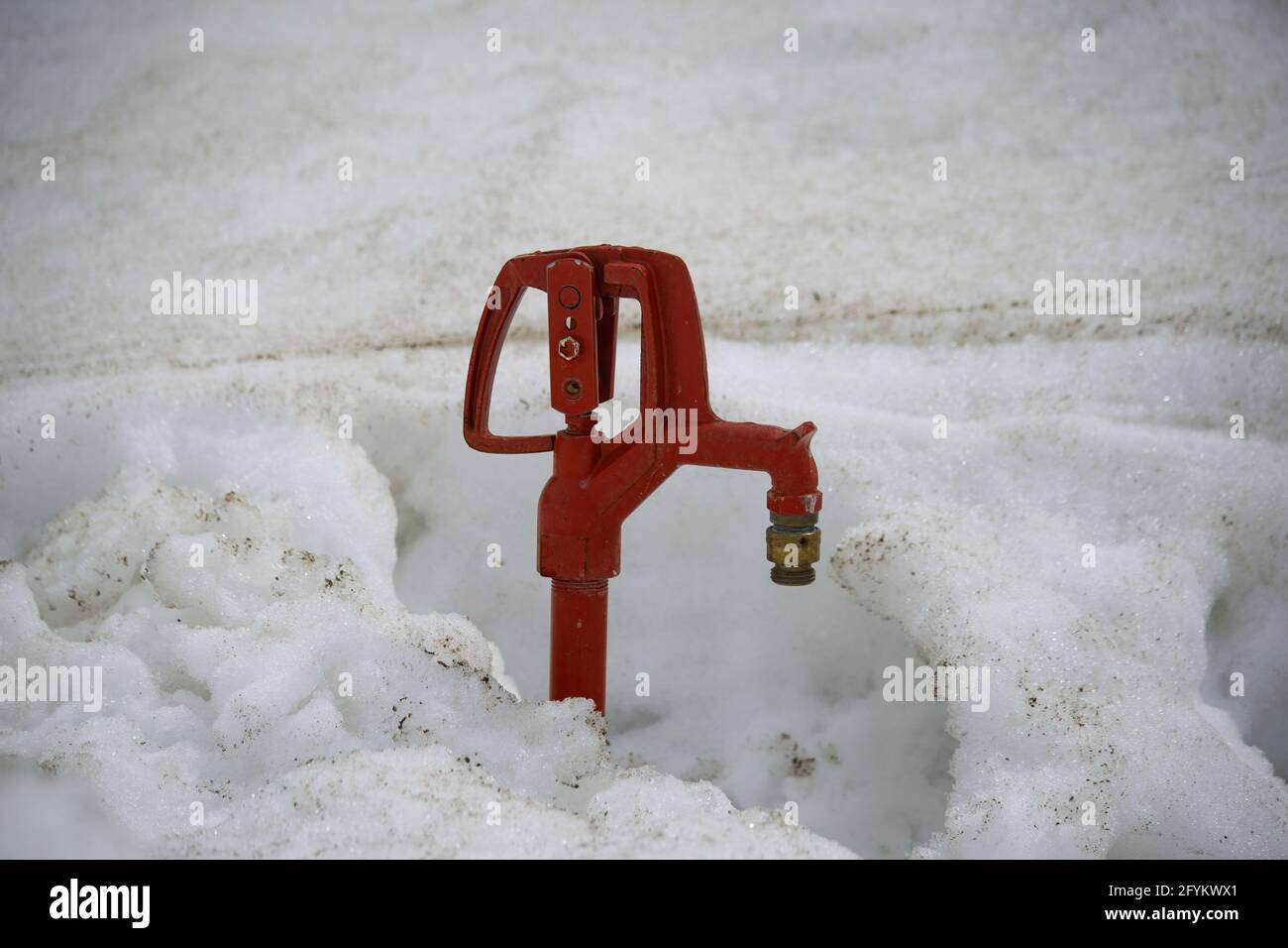 Rain barrel spigot in snow Stock Photo - Alamy