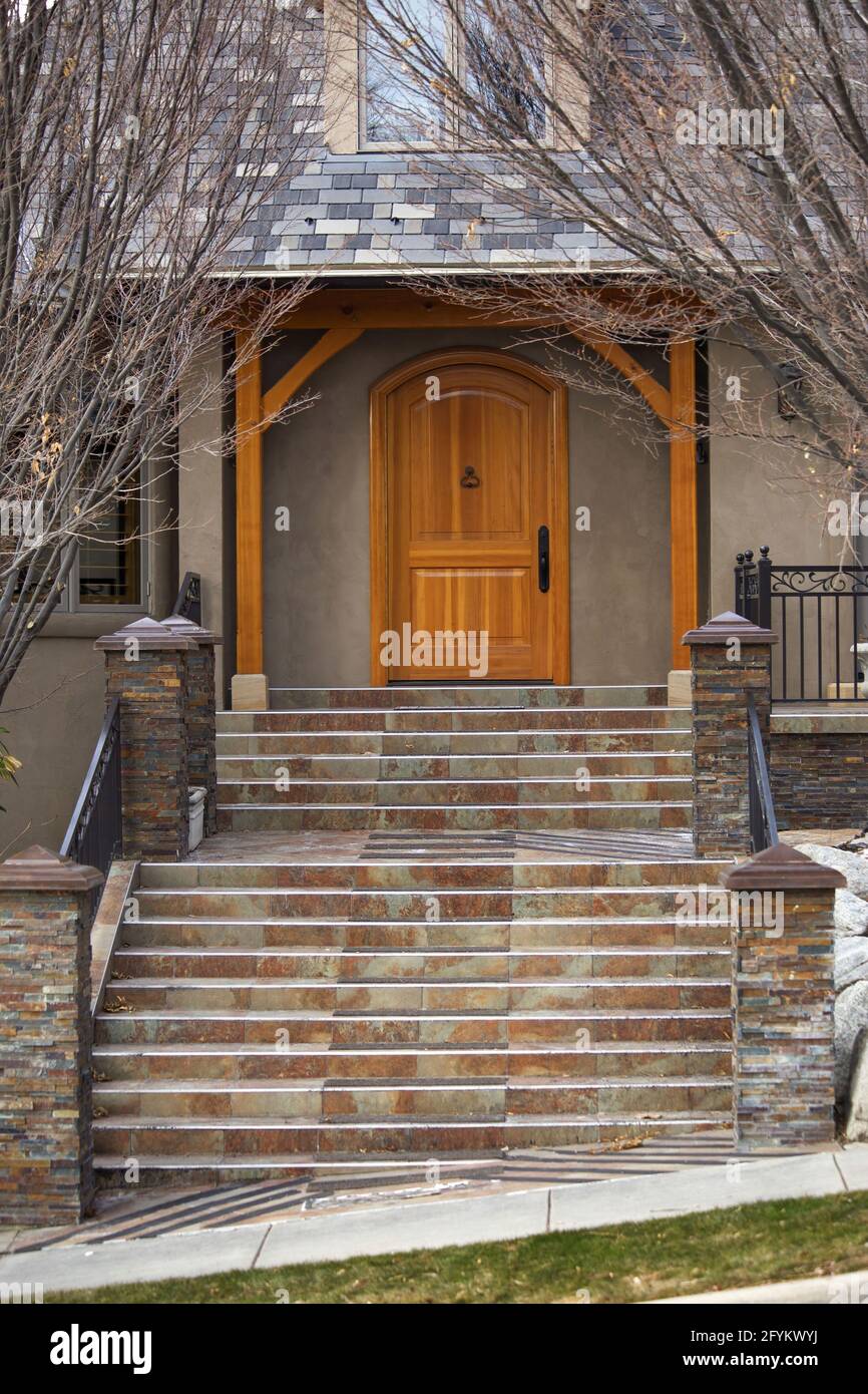 Stone house with a wooden entrance door Stock Photo - Alamy