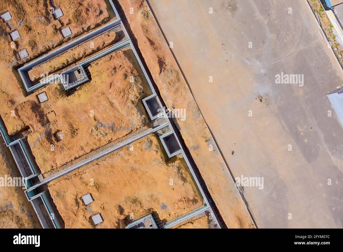 Building site of trenches dug in ground and filled with cement as ...