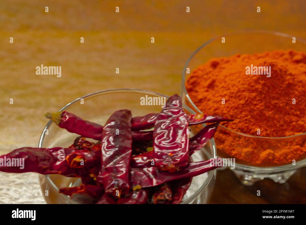 Bowl full of dry red chillies and red chilli powder kept in a bowl on a ...