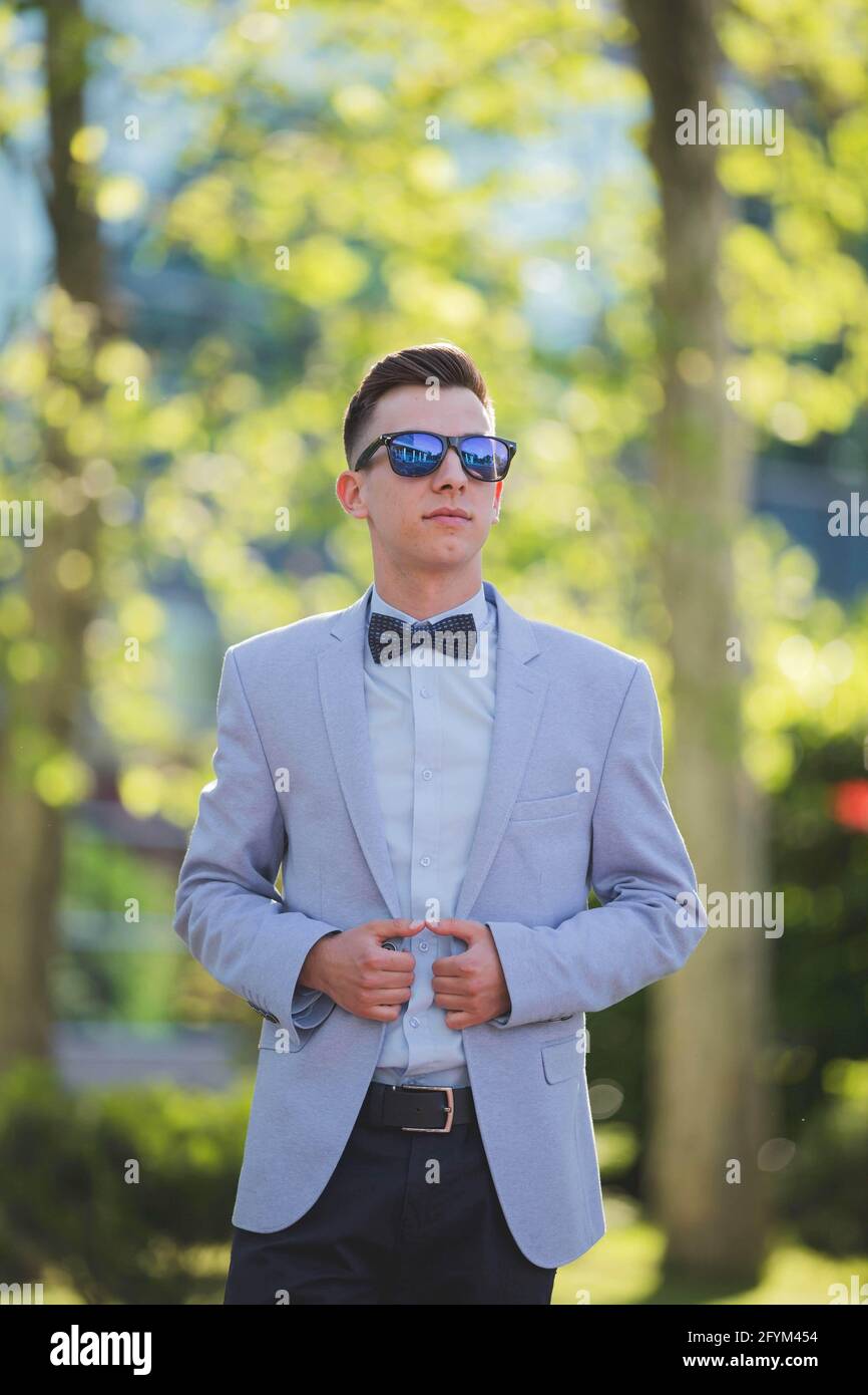 Vertical shot of a young male model posing in a light blue suit and a ...