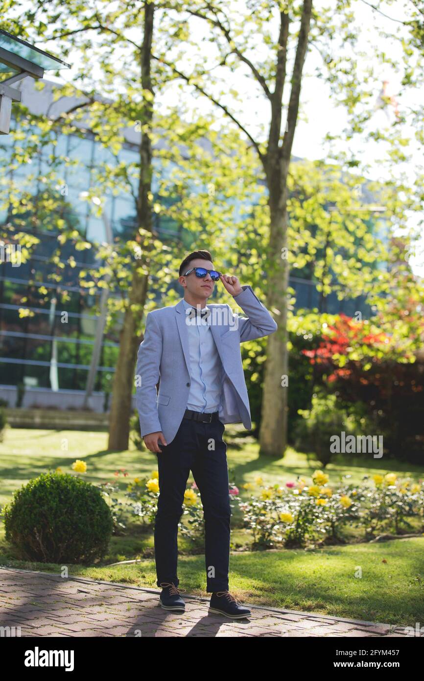 Young elegant Caucasian man wearing an expensive blue suit at an event ...