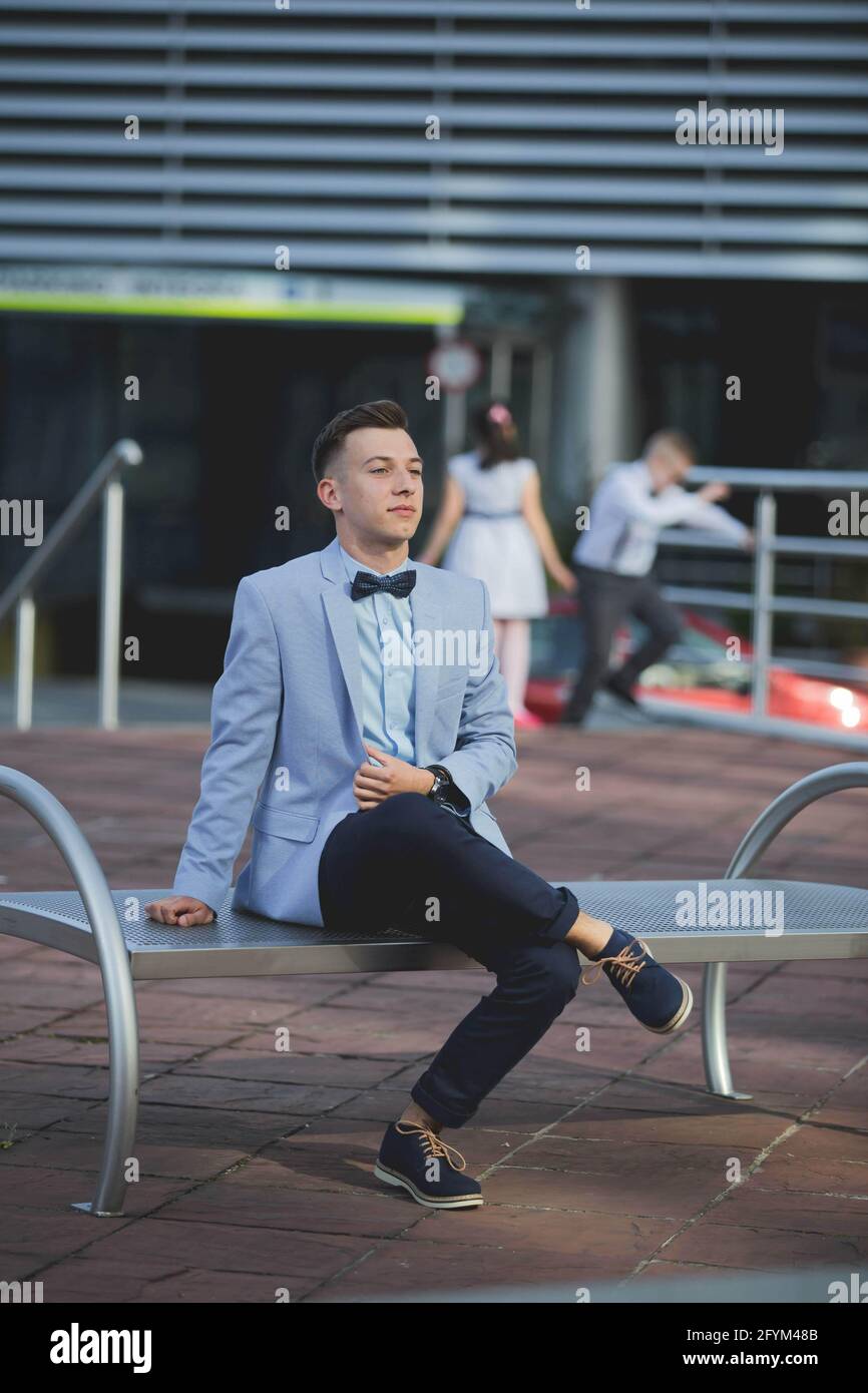 Young elegant Caucasian man wearing an expensive blue suit at an event ...
