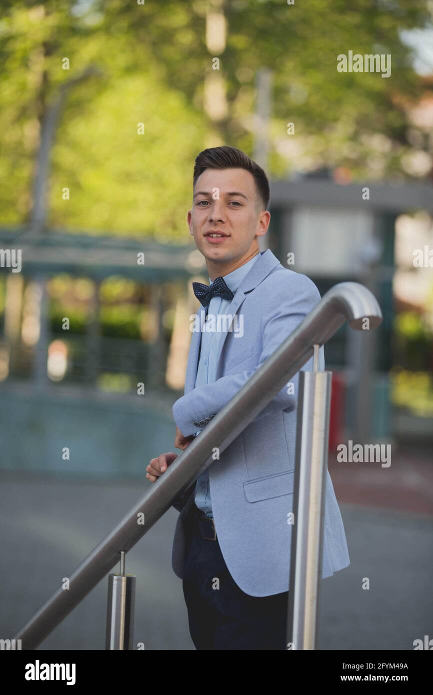 Young elegant Caucasian man wearing an expensive blue suit at an event ...