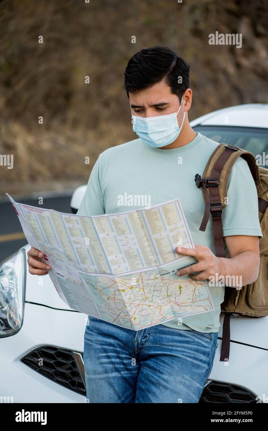 Man with mask with map in hand Stock Photo - Alamy