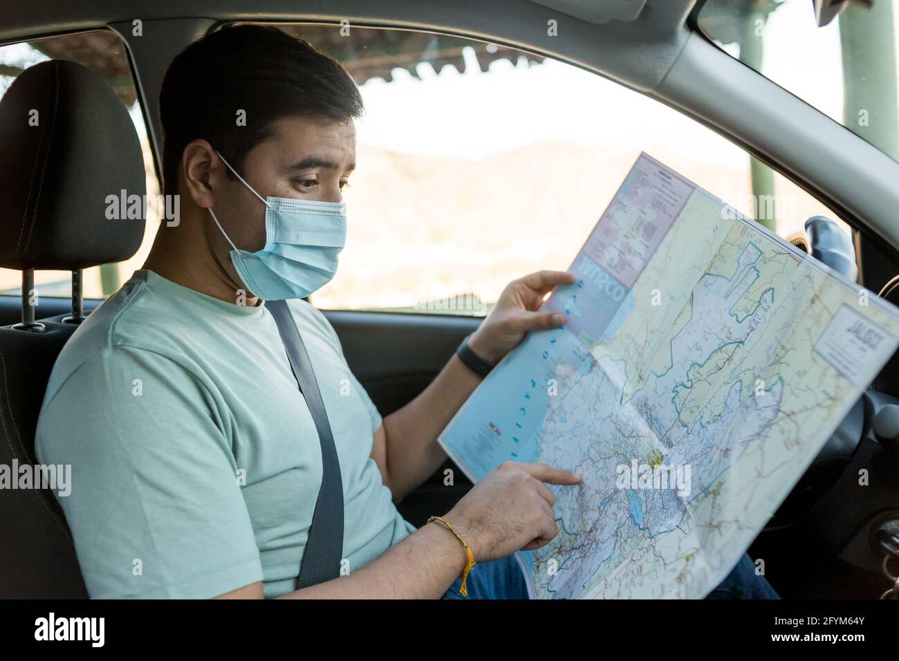 Man with mask with map in hand Stock Photo - Alamy