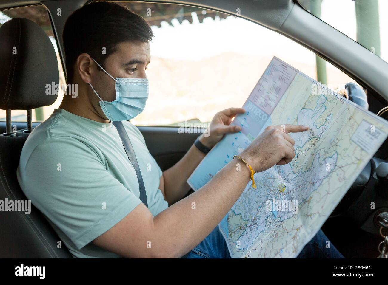 Man with mask with map in hand Stock Photo - Alamy