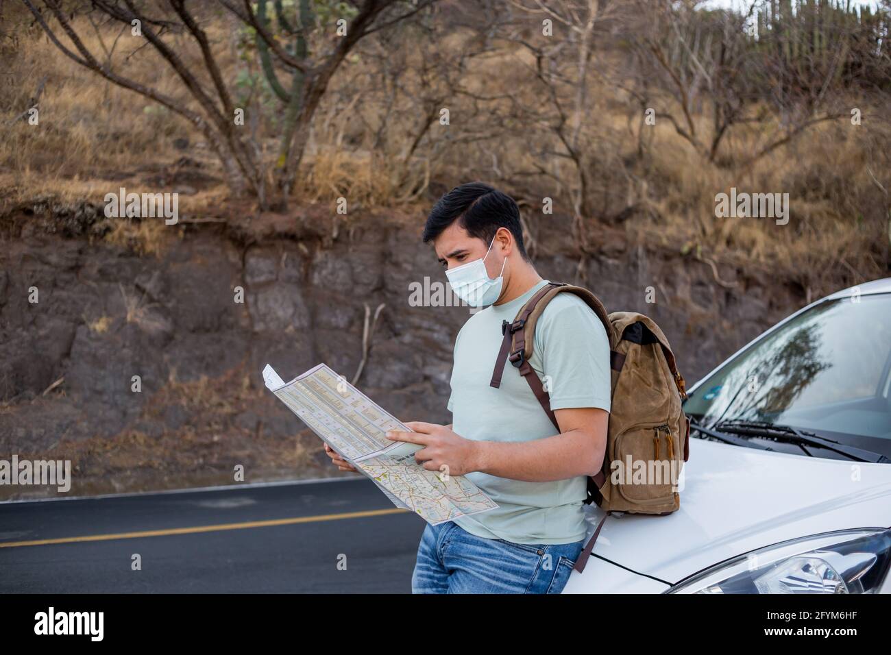 Man with mask with map in hand Stock Photo - Alamy